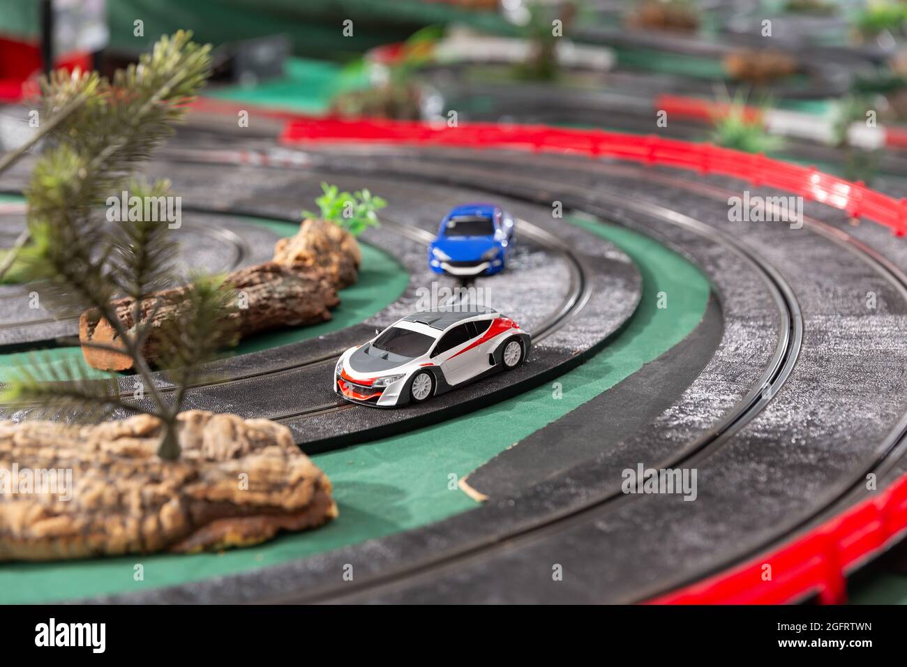 Electric slot cars on toy race track Stock Photo - Alamy