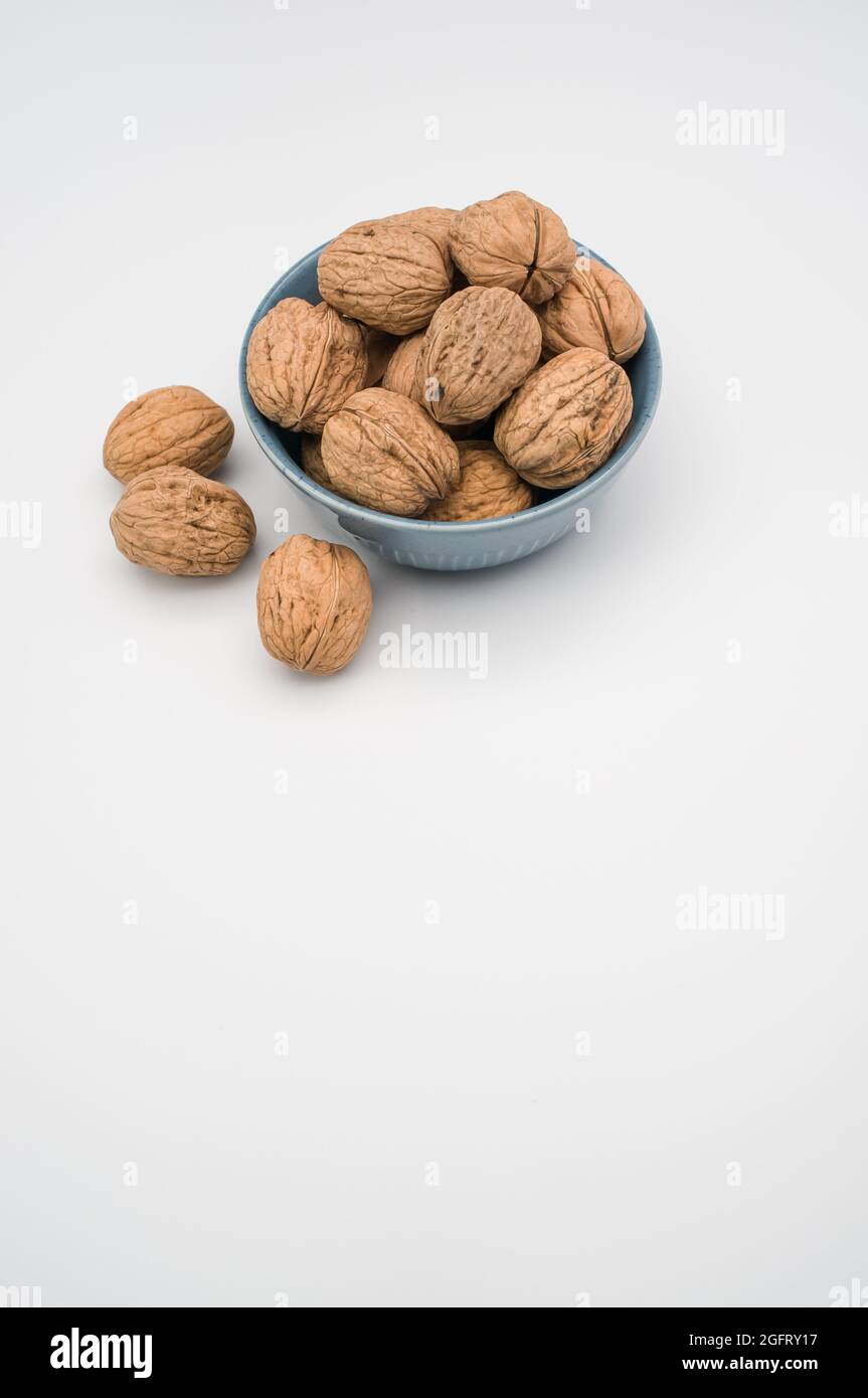 Close up of a white bowl with Stack Walnuts isolated on a white Stock ...
