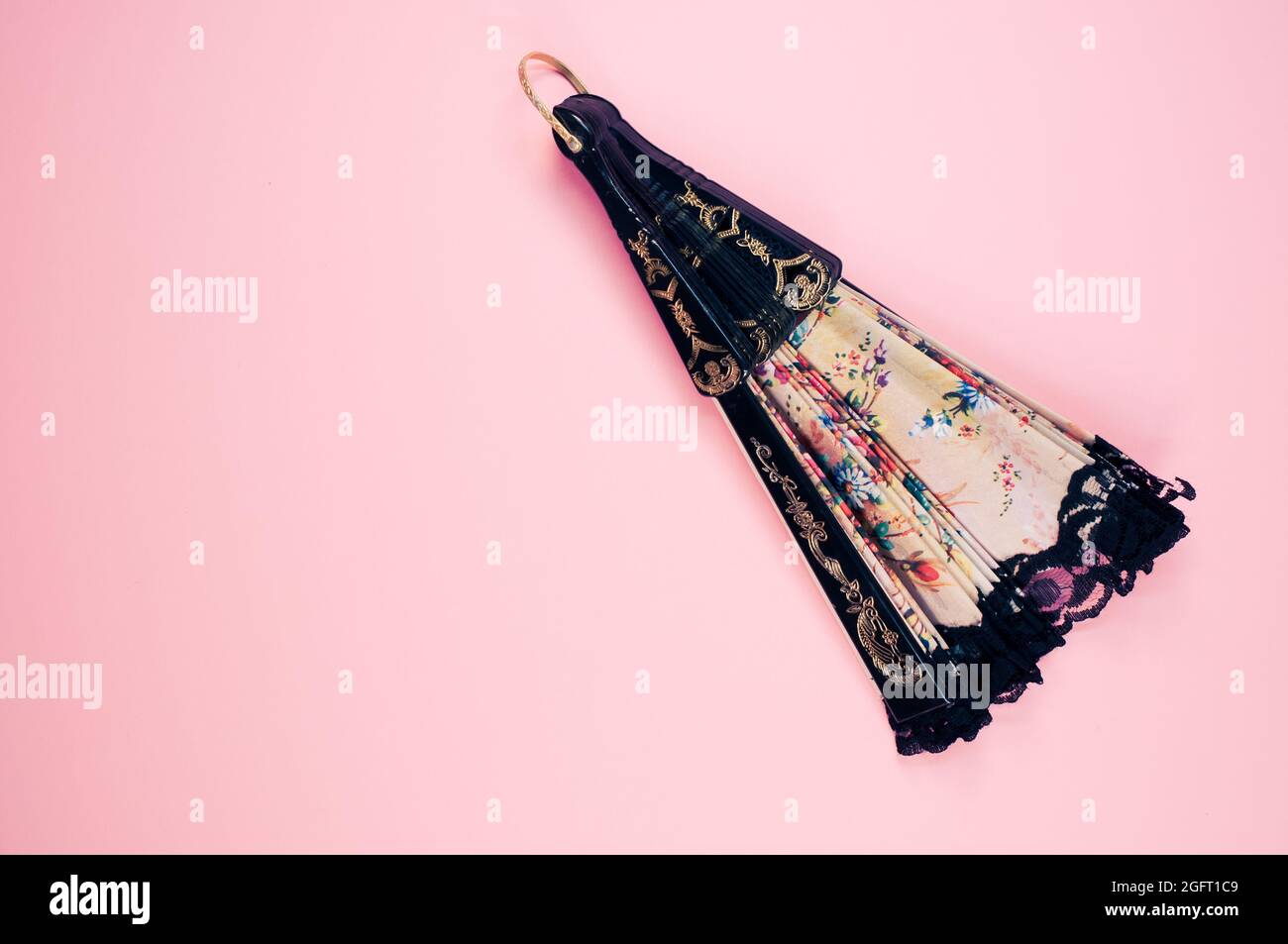 Top view of a beautiful floral hand fan on the pink surface Stock Photo ...