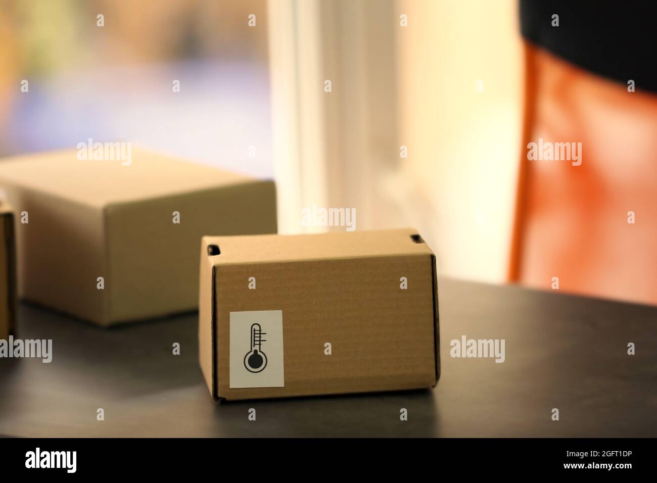 Carton boxes on table in room Stock Photo - Alamy