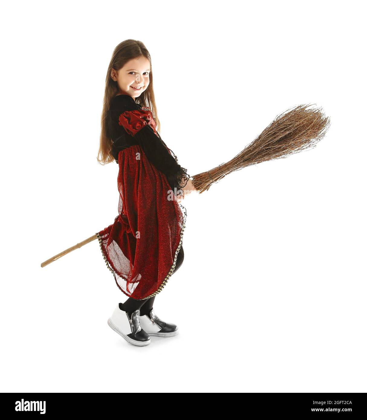 Cute girl with broom in Halloween costume on light background Stock ...