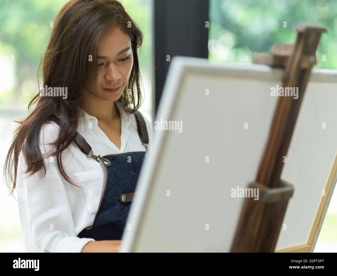 Closeup, Confident female painter painting on canvas, create ...