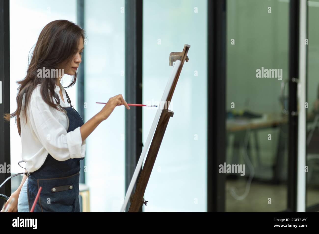 Attractive professional female artist drawing an inspiration artwork on ...