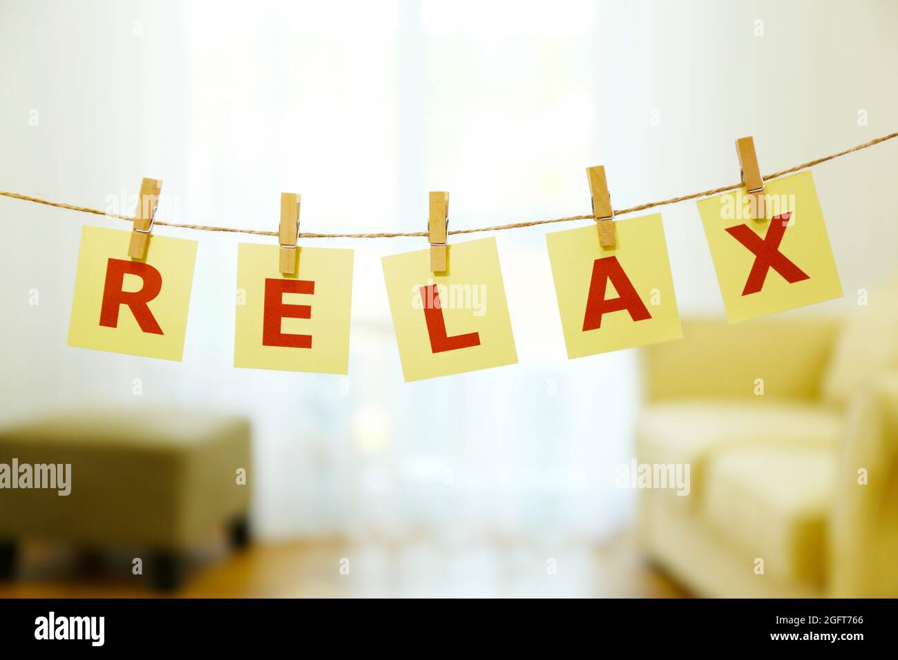 Cards with printed word RELAX on blurred room background Stock Photo ...
