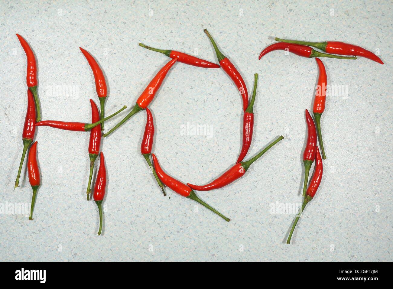 Red Hot Chili Pepper Arranged To Form Hot Word On Top Light Colored ...