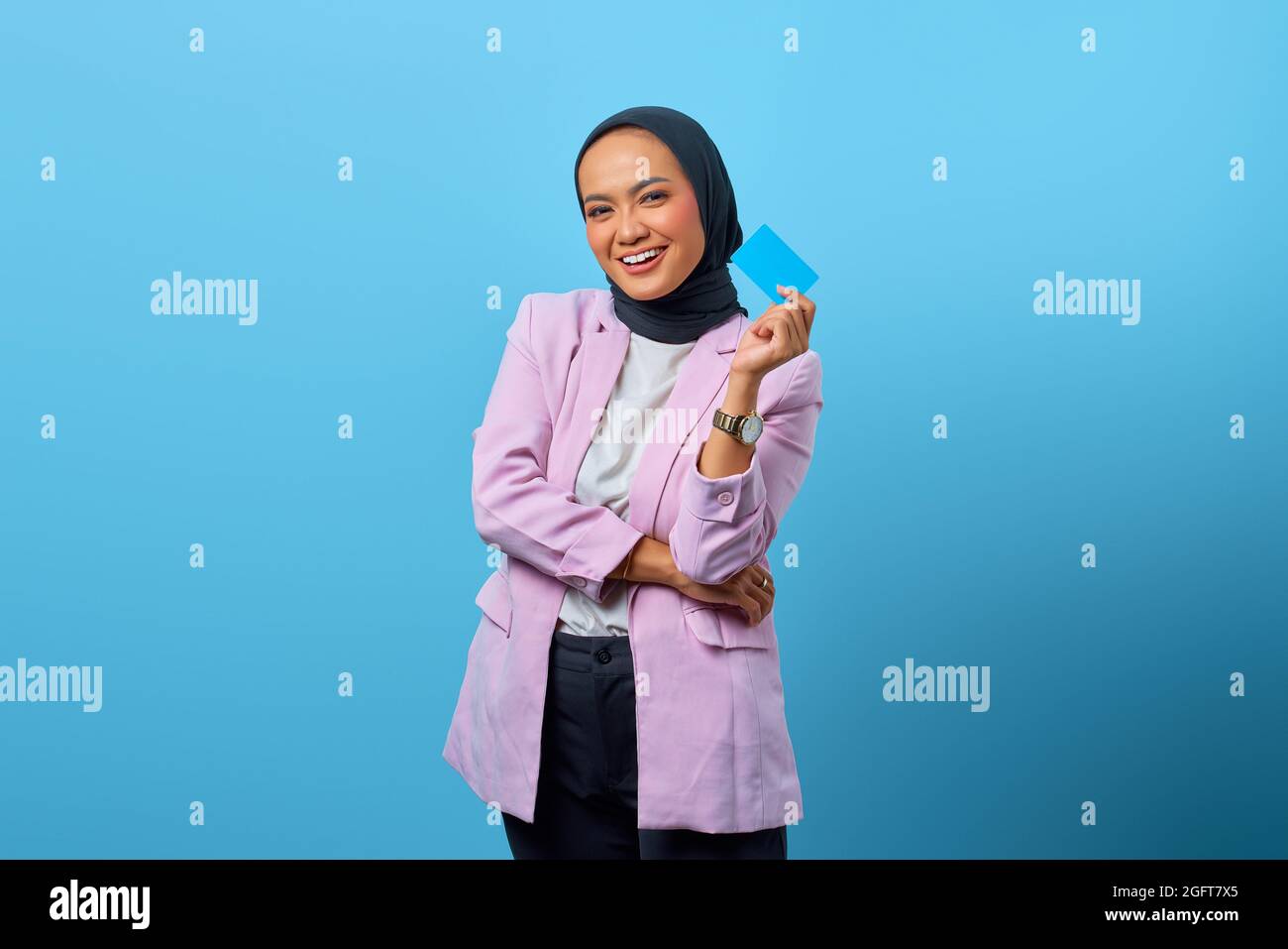 Portrait of attractive Asian woman laughing and holding credit card ...
