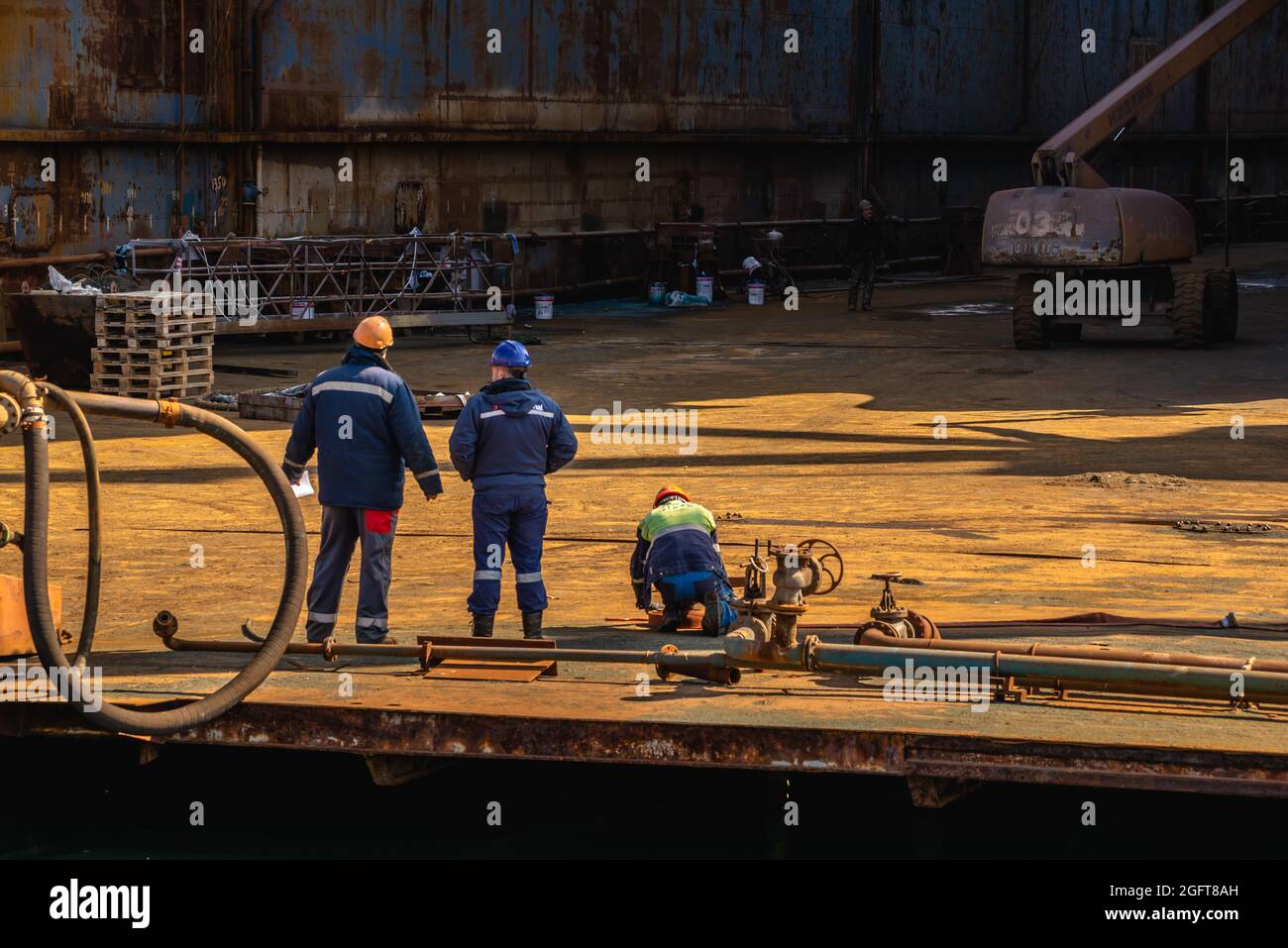 Chernomorsk, Ukraine. 21.03.2021. Dry dock workers in the dock of the ...