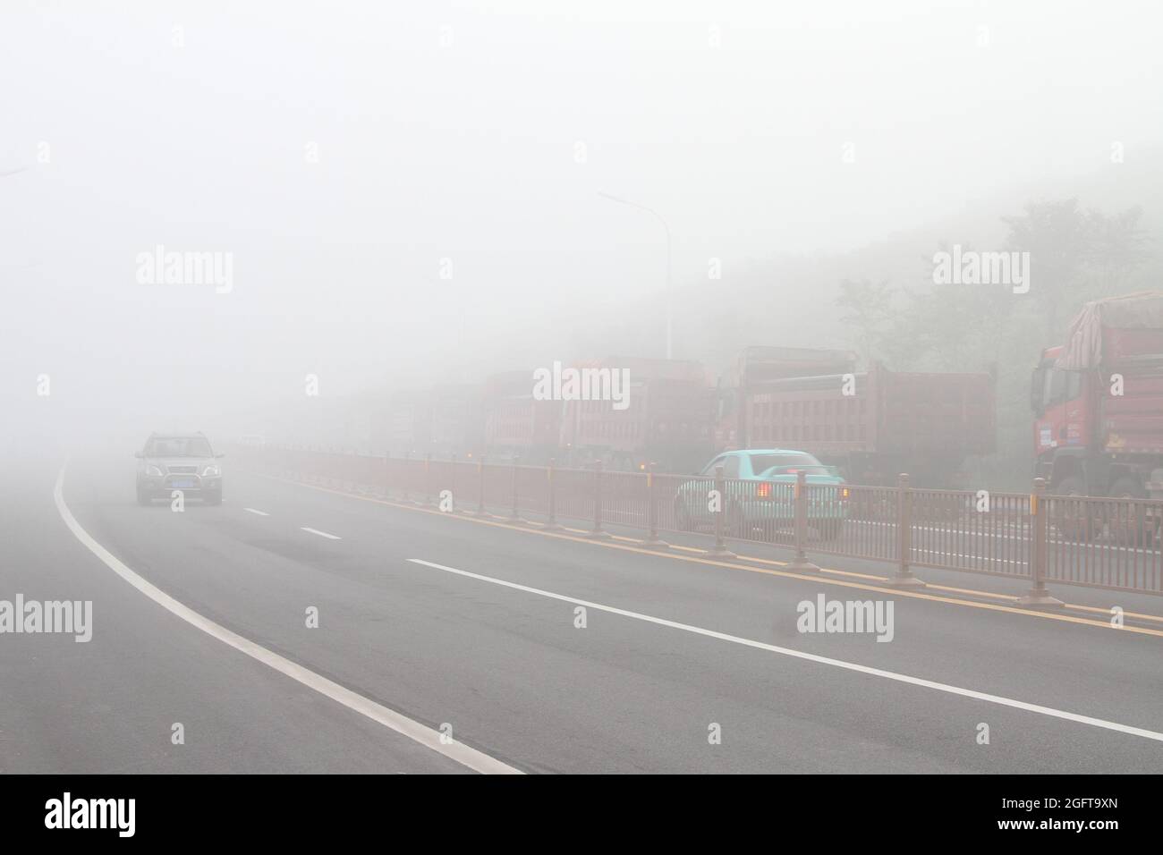 People commute during the foggy weather in Weihai city, east China's ...
