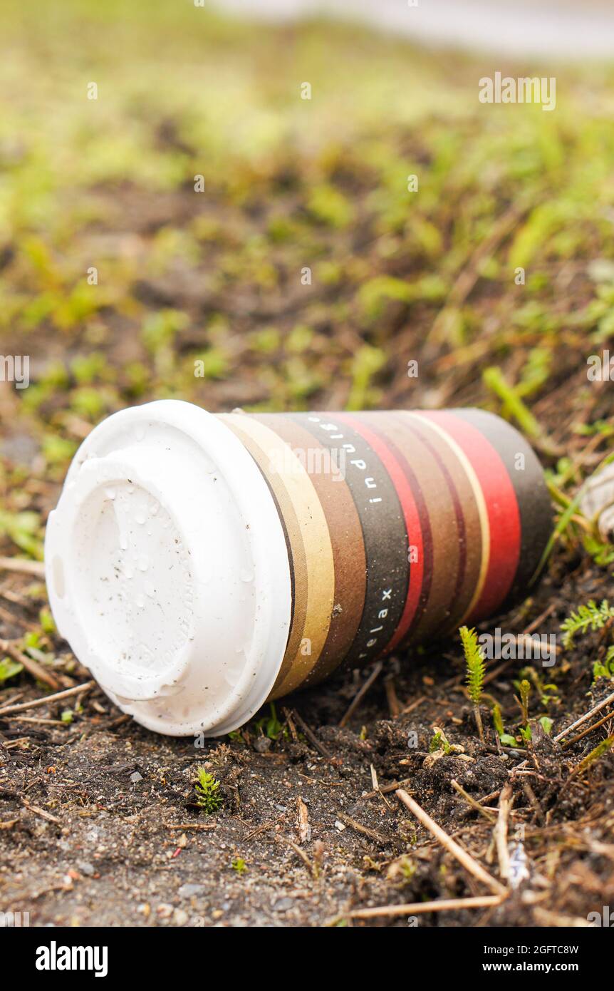 Vertical shot of a paper coffee cup laying on the ground Stock Photo ...