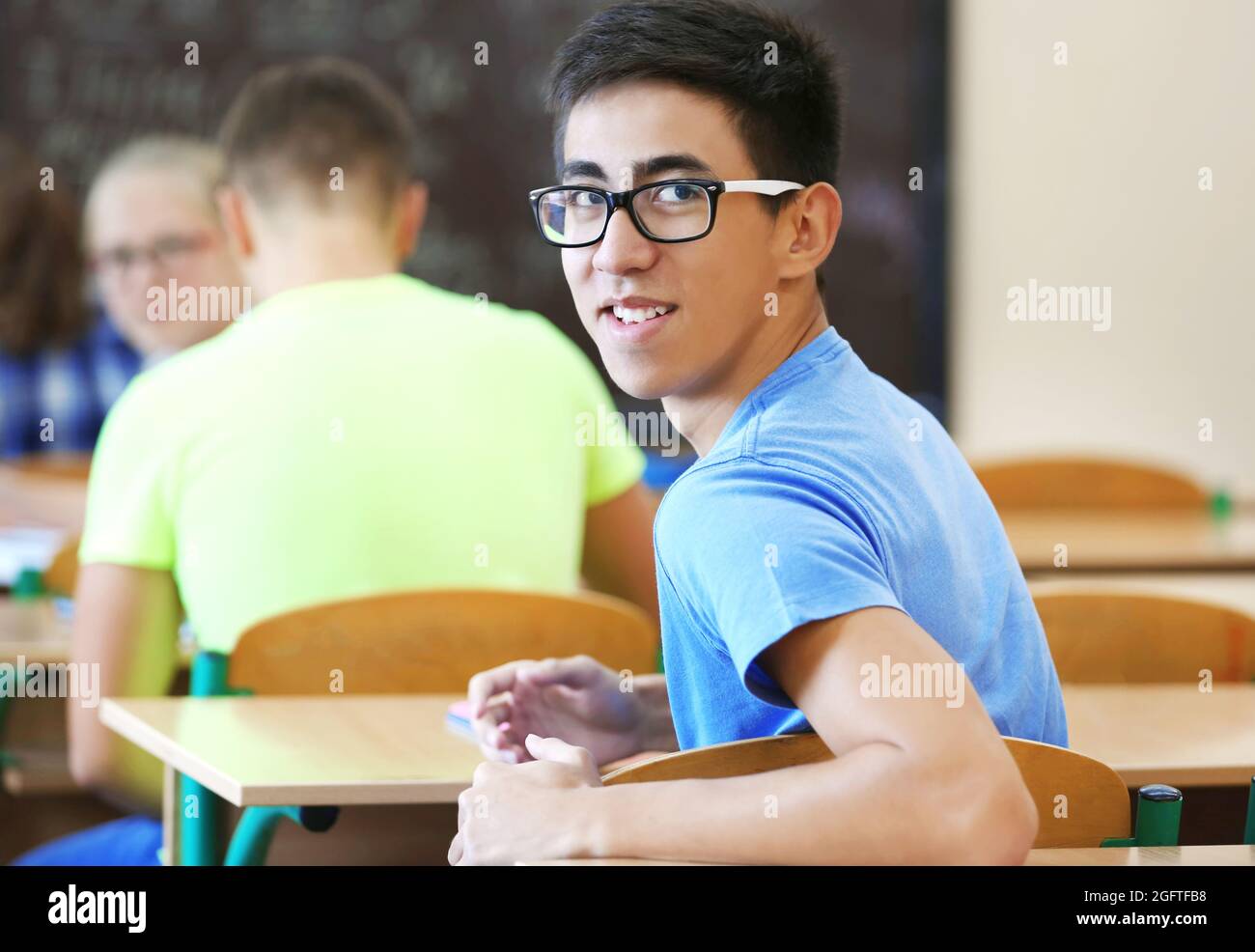 Student with group of classmates in classroom Stock Photo - Alamy