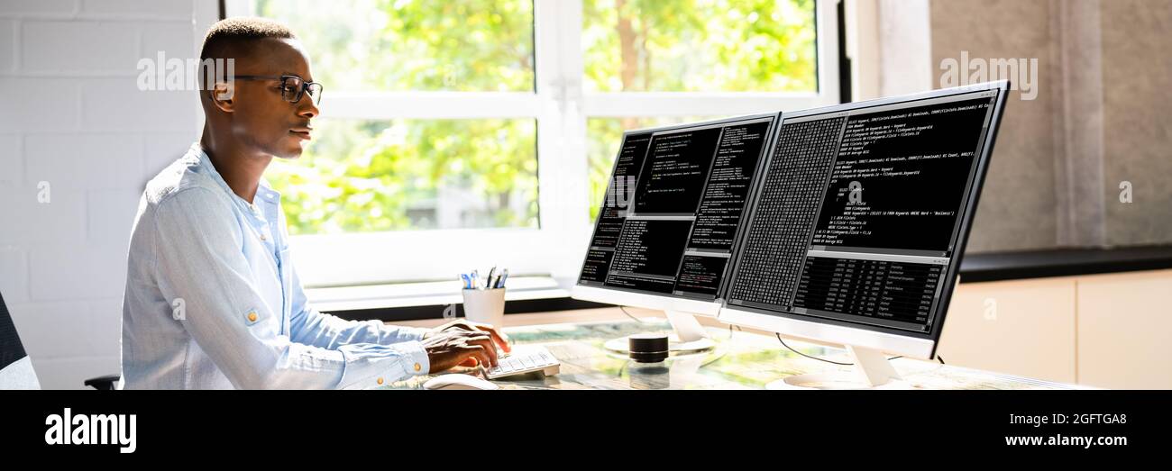 African American Coder Using Computer At Desk. Web Developer Stock Photo - Alamy
