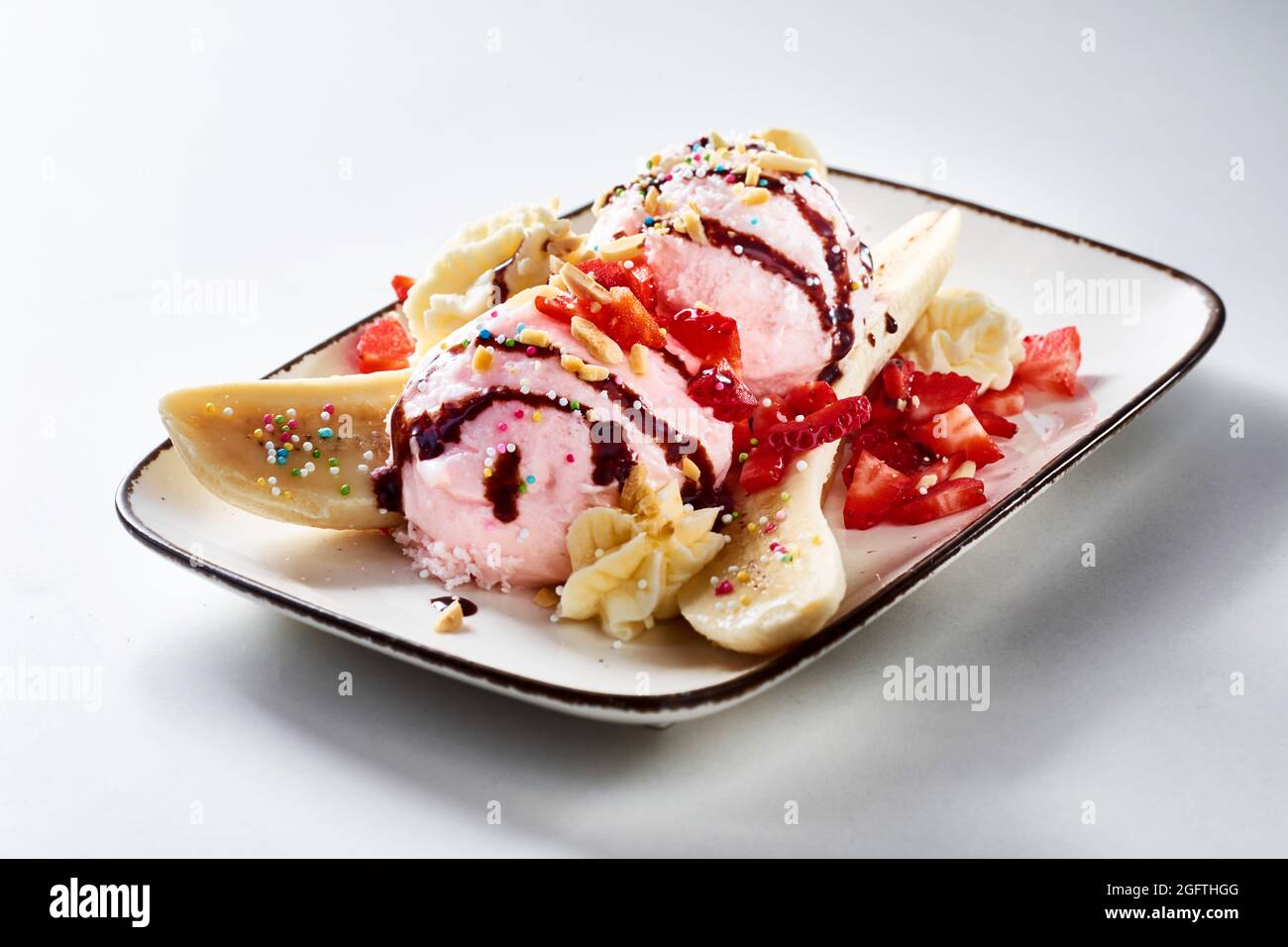 Gourmet banana split sundae with fresh summer strawberries, berry ice ...