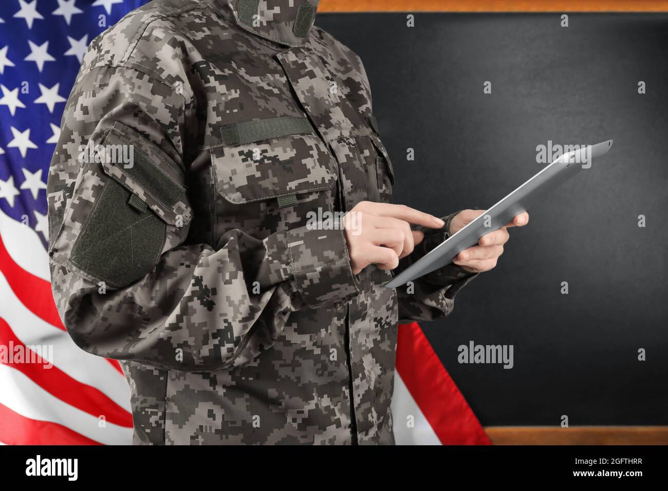 Soldier holding tablet. Military education concept Stock Photo - Alamy