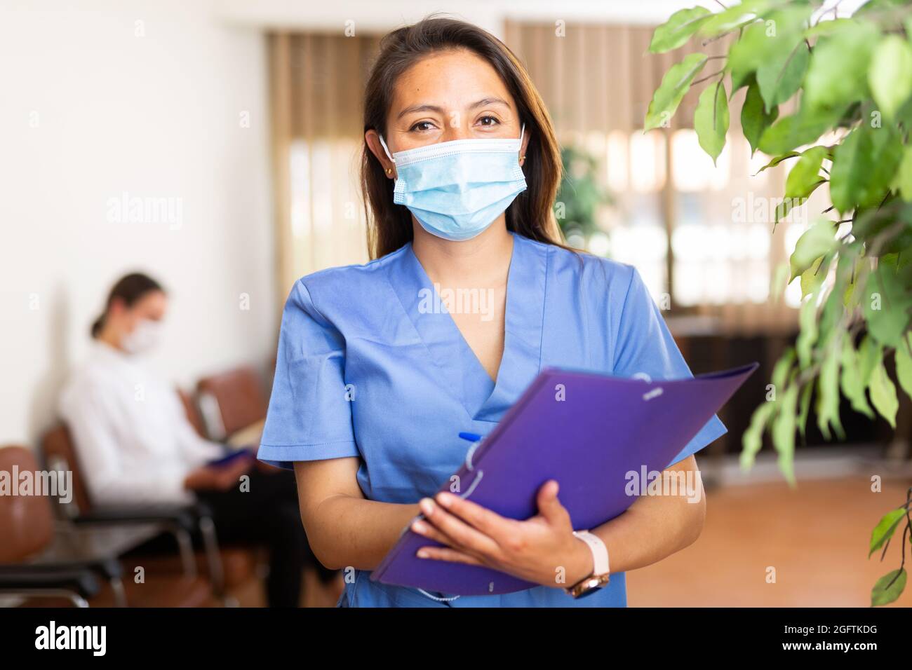 Positive woman doctor standing in office Stock Photo - Alamy