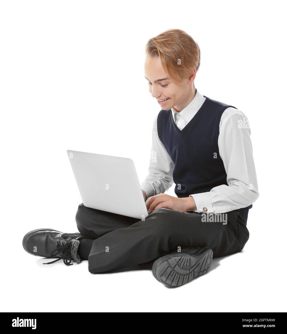 Teenage boy with laptop sitting on white background Stock Photo - Alamy
