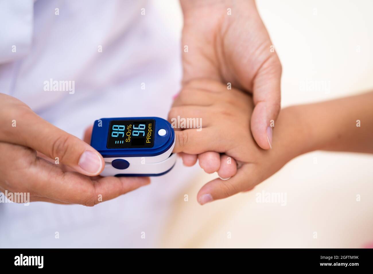 Doctor Checking Child Blood Pulse Using Oximeter Stock Photo - Alamy