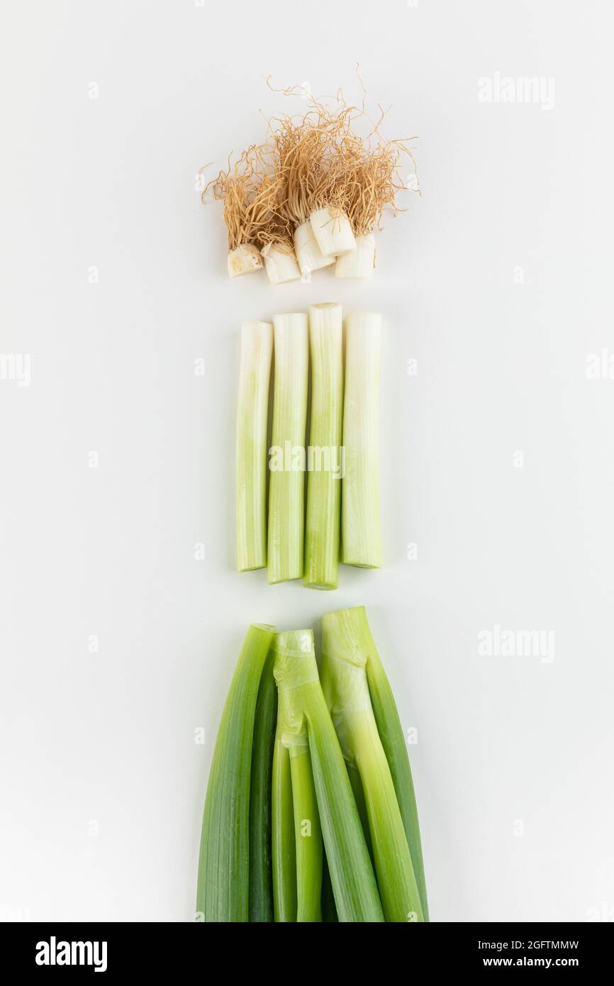 sliced green onion, root stem and leaf on white background Stock Photo ...