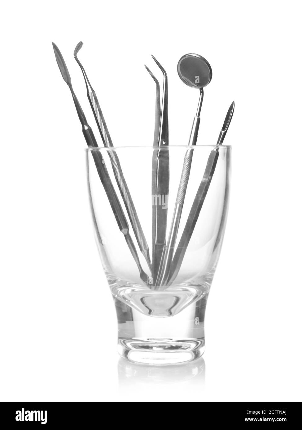Dental equipment in glass on white background Stock Photo - Alamy
