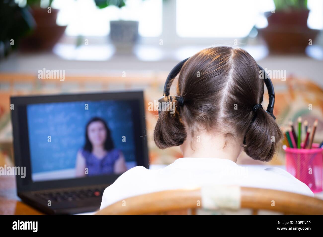 Distance learning-online education. School girl watching online ...