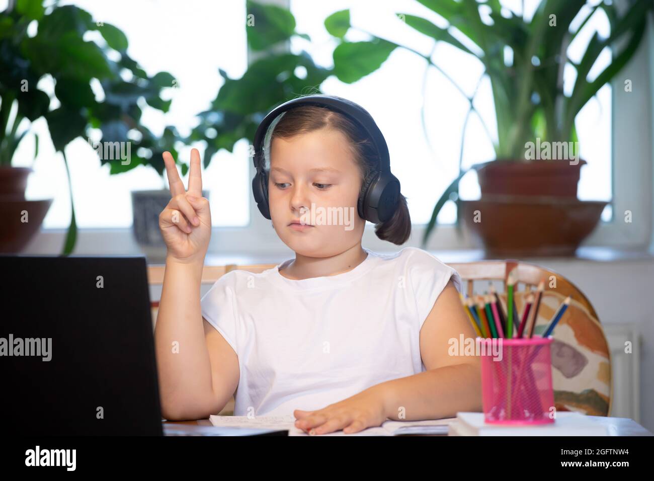 Distance learning-online education. School girl watching online ...