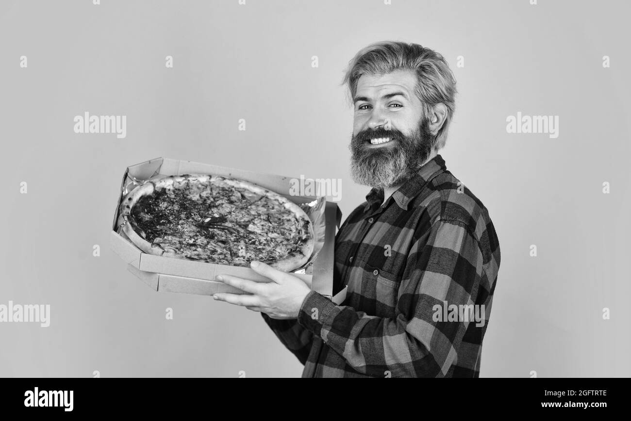 In mood for Italian food. Man bearded hipster hold cardboard pizza box ...