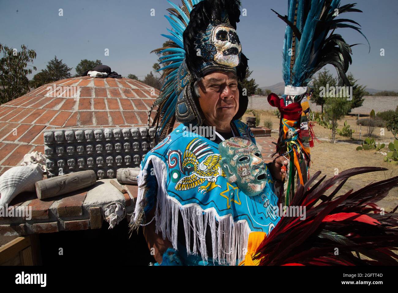 A man poses dressed as aztec warrior front a Temazcal as part of a pre ...
