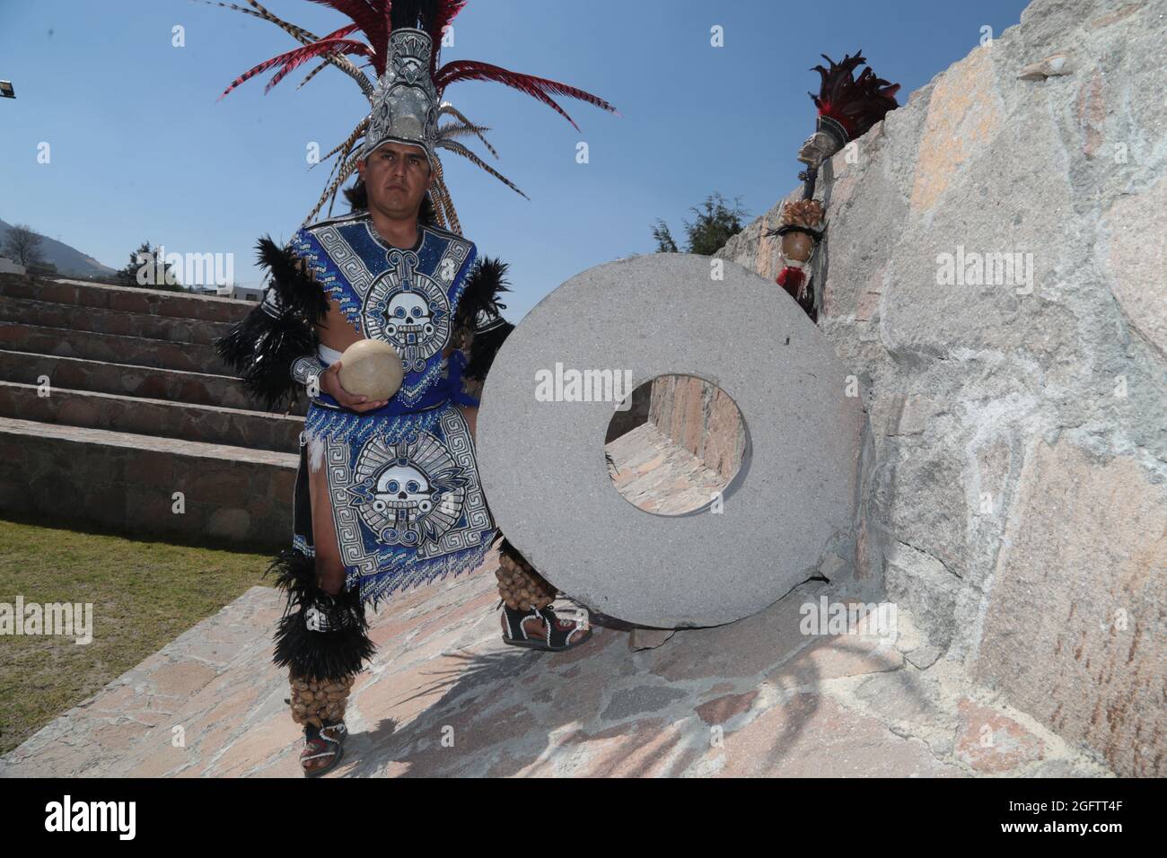 A man poses dressed as aztec warrior at aztec ball game area as part of ...