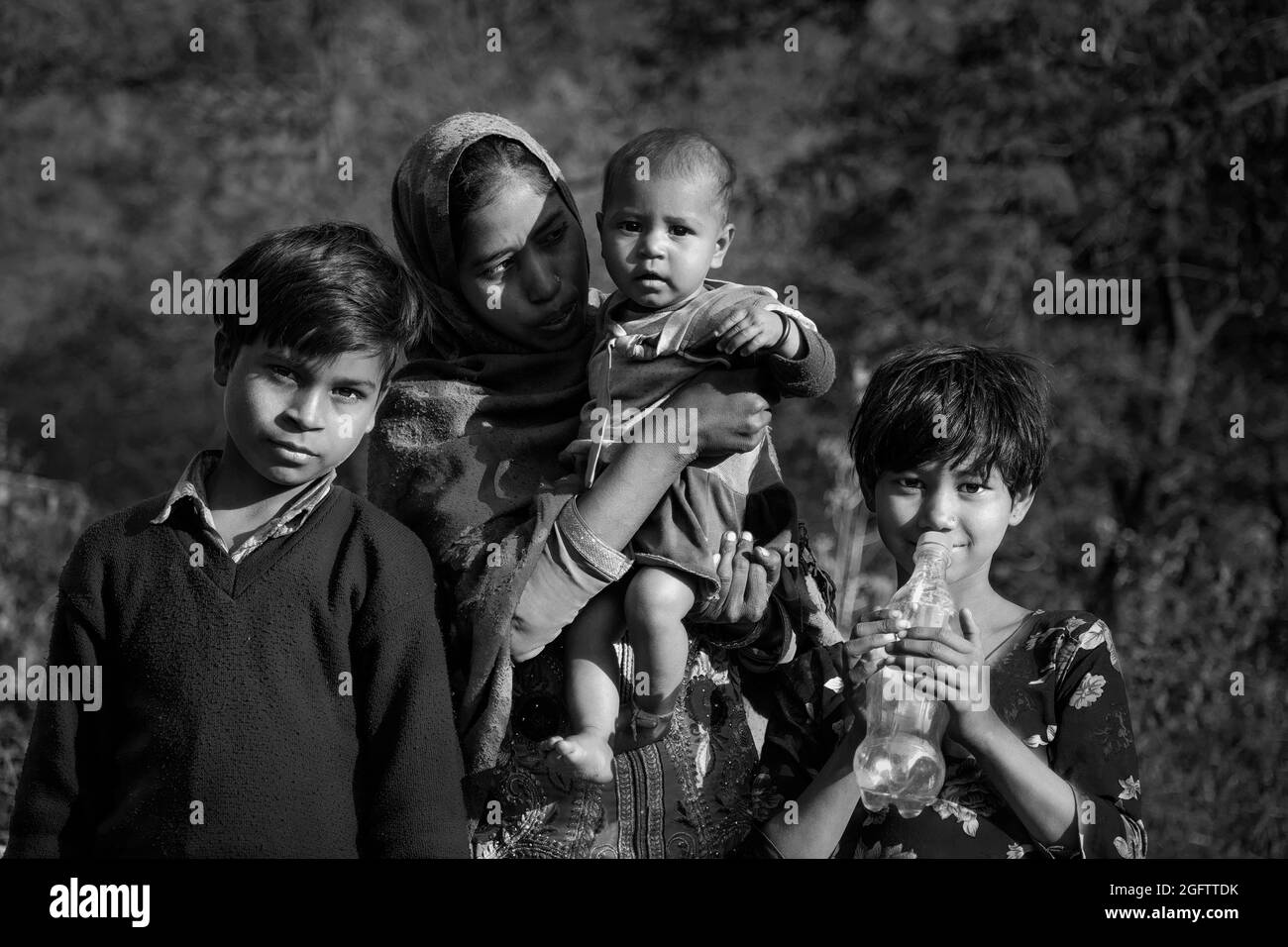Black and white street portraiture of a homeless family with mother and ...