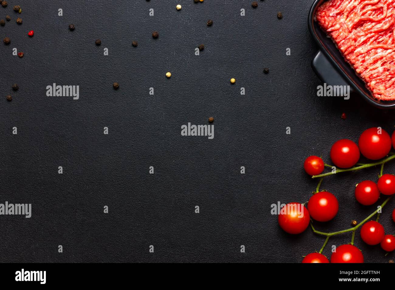 Culinary frame background in dark shades with minced meat, pepper ...