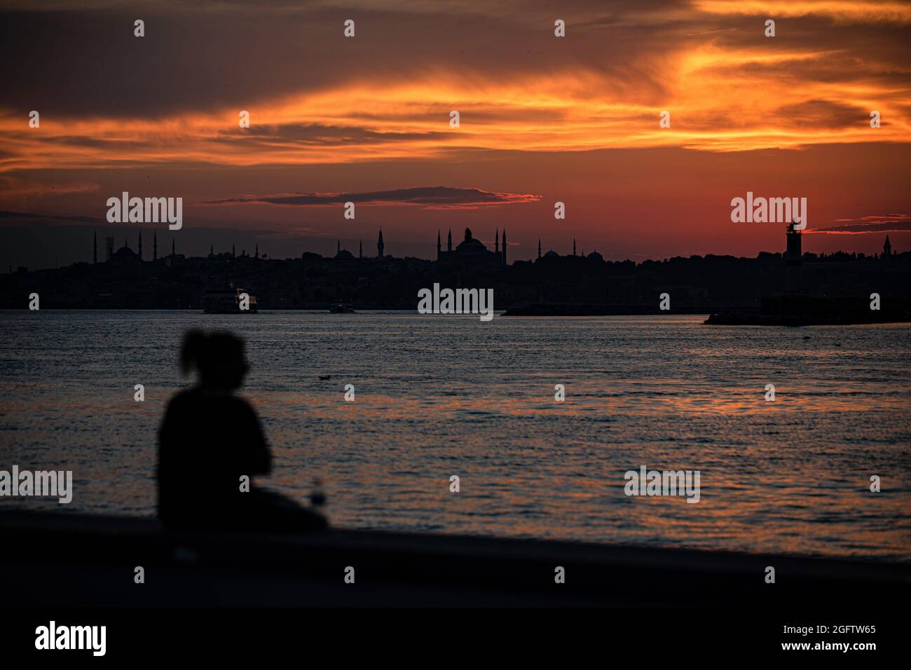 Istanbul, Turkey. 28th June, 2021. A silhouette of a woman sitting on ...