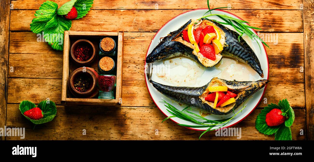 Fish roasted with berries and lemon.Summer fish dish,baked mackerel on ...
