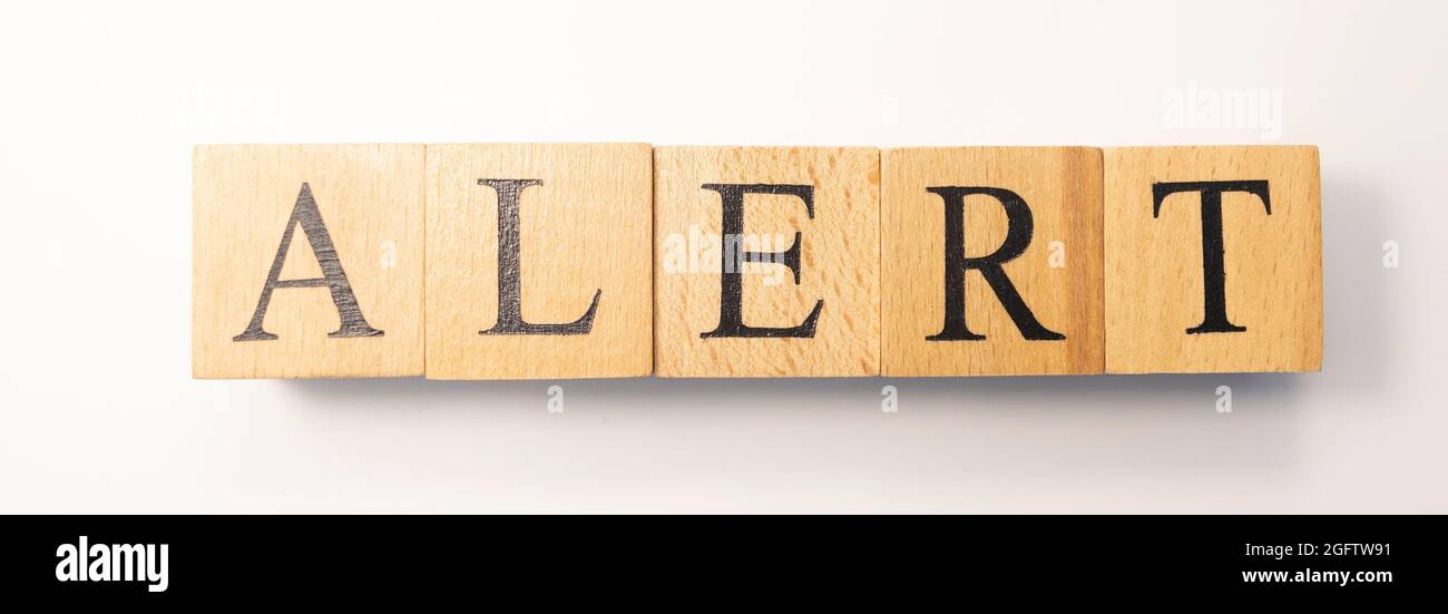 The word ALERT was created from wooden cubes. Health and life. Close-up ...