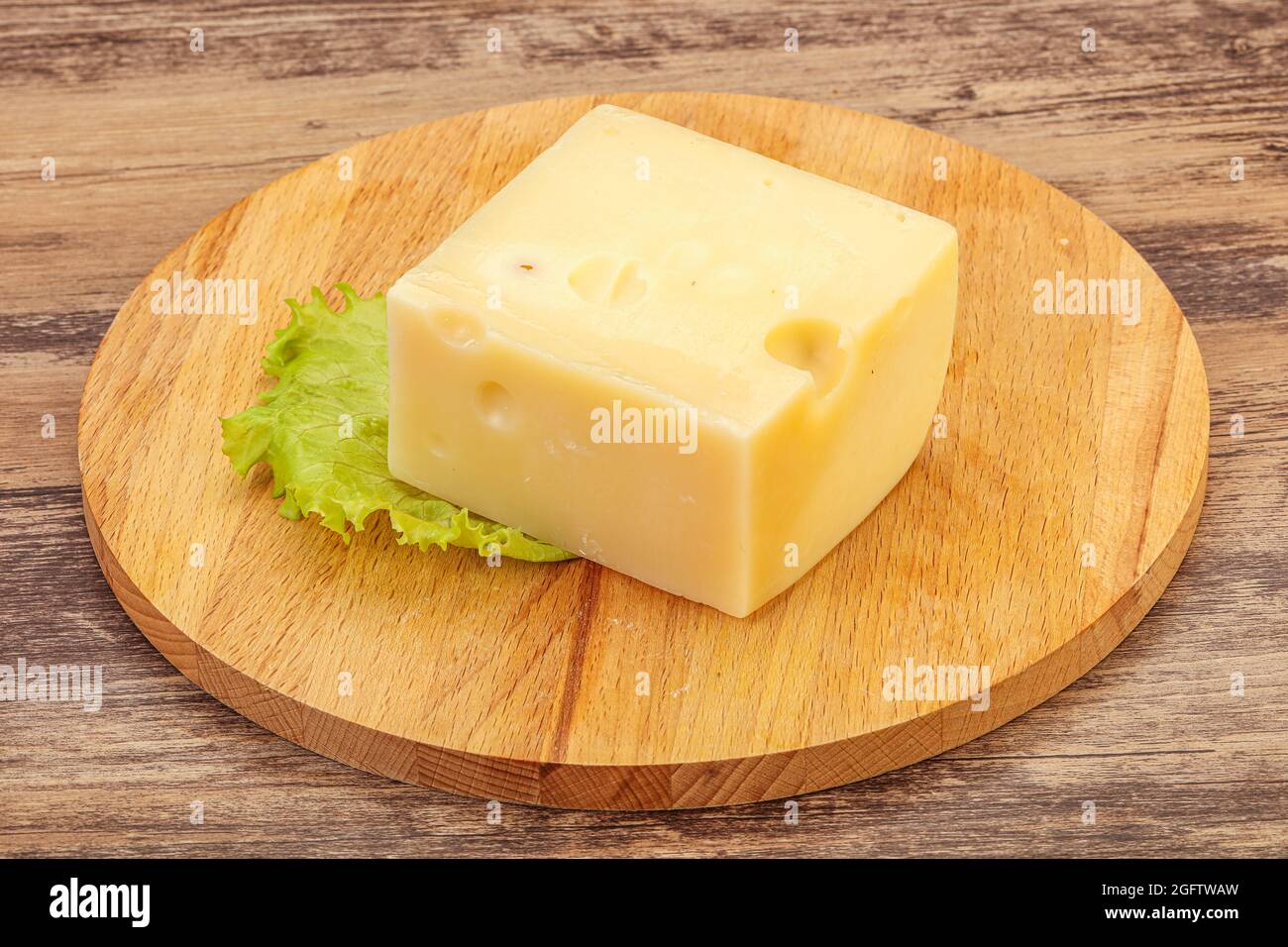 Emmental cheese over wooden board served salad Stock Photo - Alamy