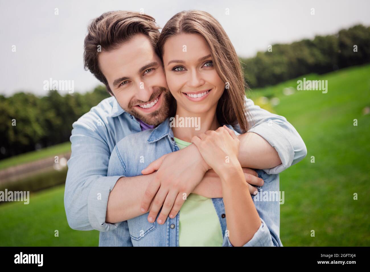 Portrait of smiling cheerful cute lovely couple boyfriend hug embrace ...
