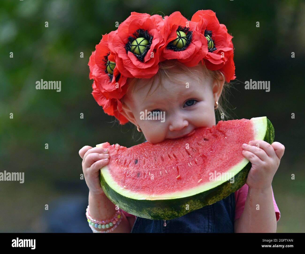 SIEVIERODONETSK, UKRAINE - AUGUST 24, 2021 - A little girl in a poppy ...