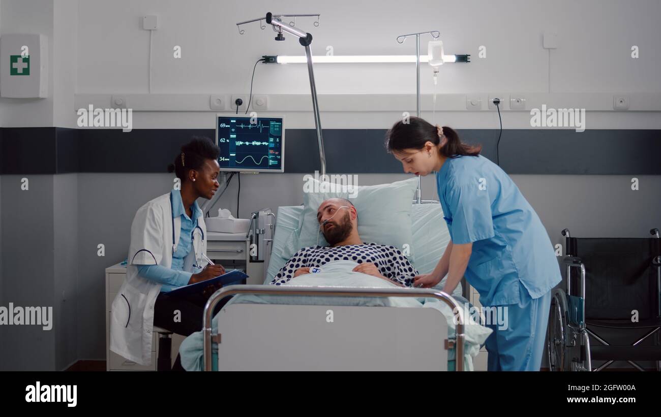 Practitioner afro american doctor discussing with sick man disease ...