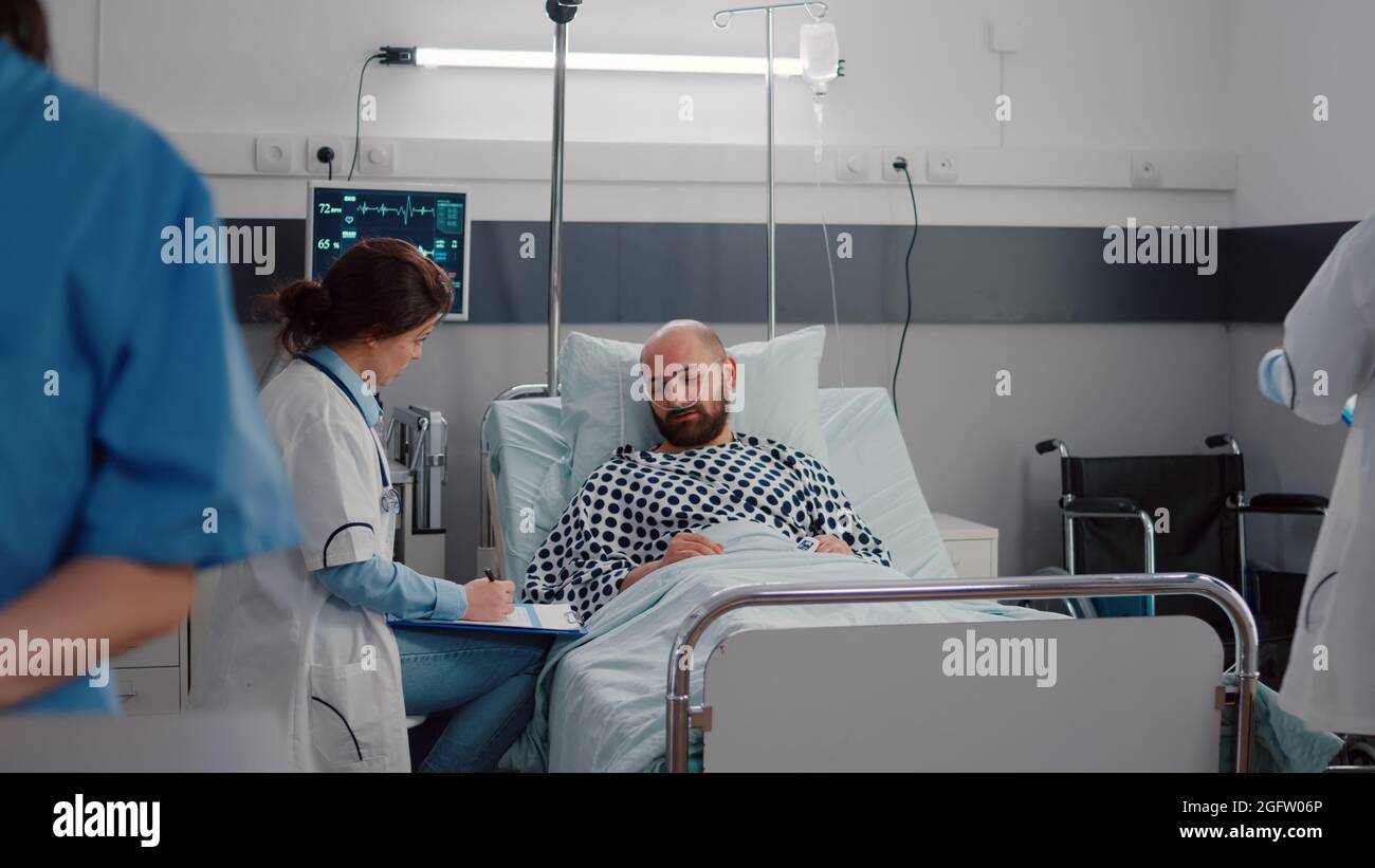 Medical practitioner doctors examining sick man checking sickness ...