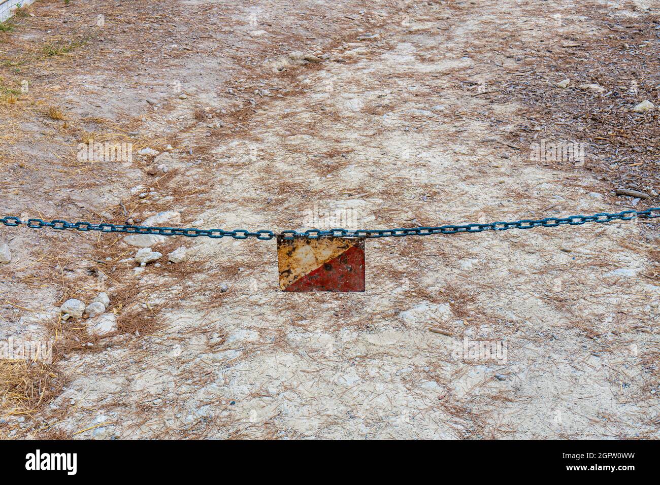 Metal chain with a rustic sign hanging on it isolated on a background ...