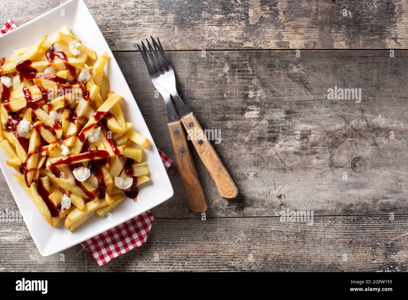 Traditional Canadian Poutine on wooden table Stock Photo - Alamy