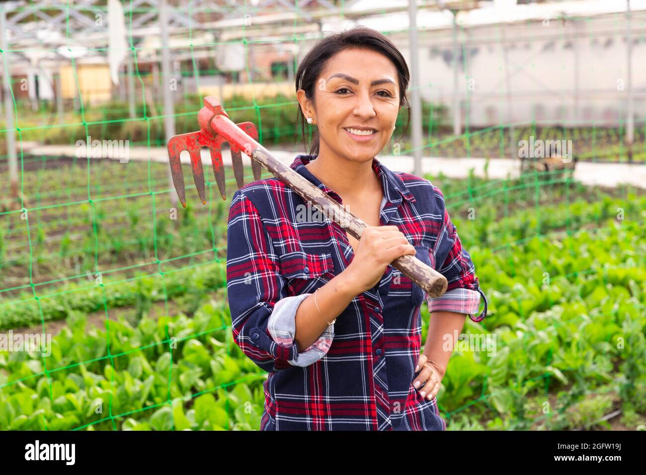 woman gardener worker standing with rake Stock Photo - Alamy
