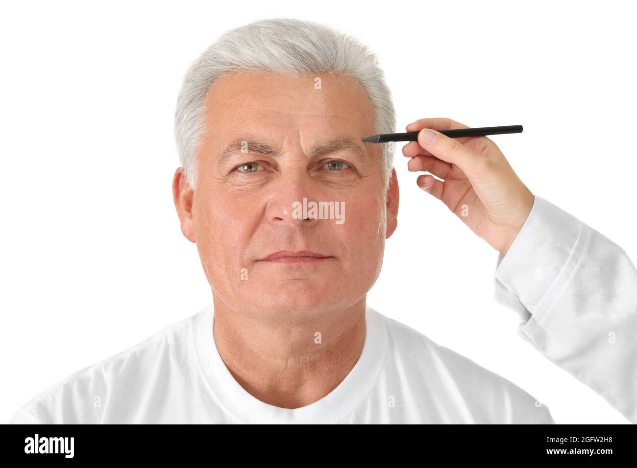 Female hand drawing correction line on man's face on white background ...