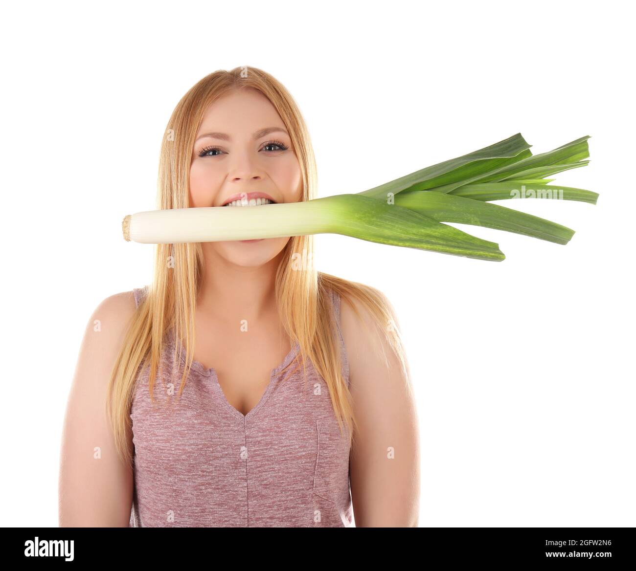 Young woman holding leek in mouth on white background Stock Photo - Alamy