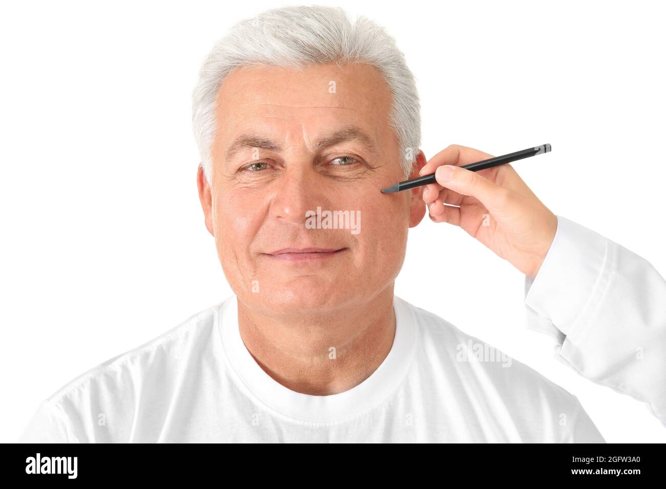 Female hand drawing correction line on man's face on white background ...
