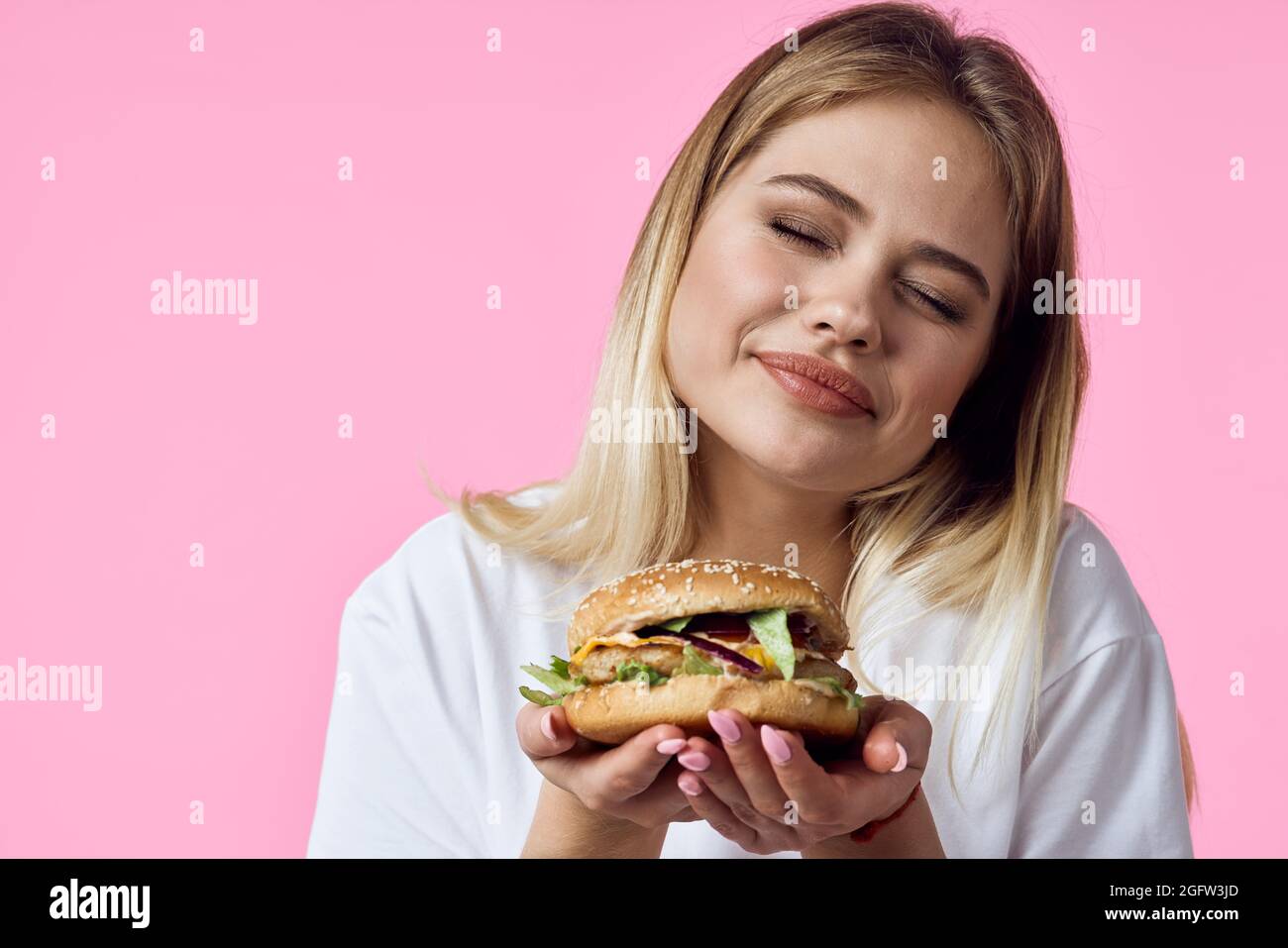 Young woman eating burger model hi-res stock photography and images - Alamy