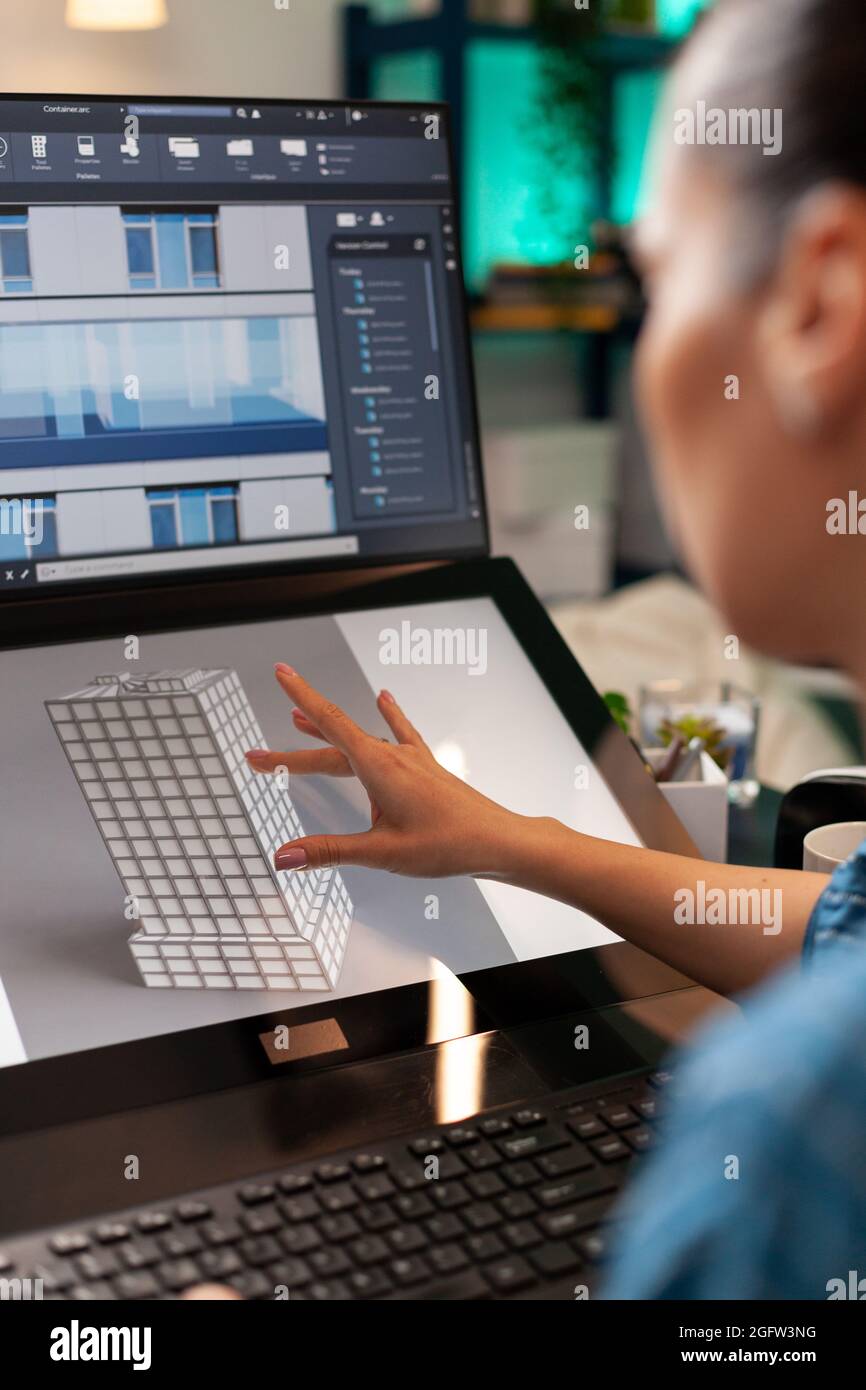 Professional woman architect working on building plan using modern ...