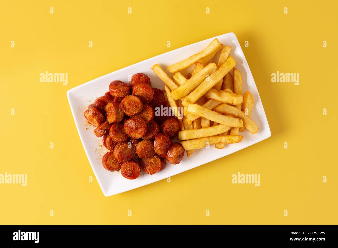 Traditional German currywurst on yellow background Stock Photo - Alamy