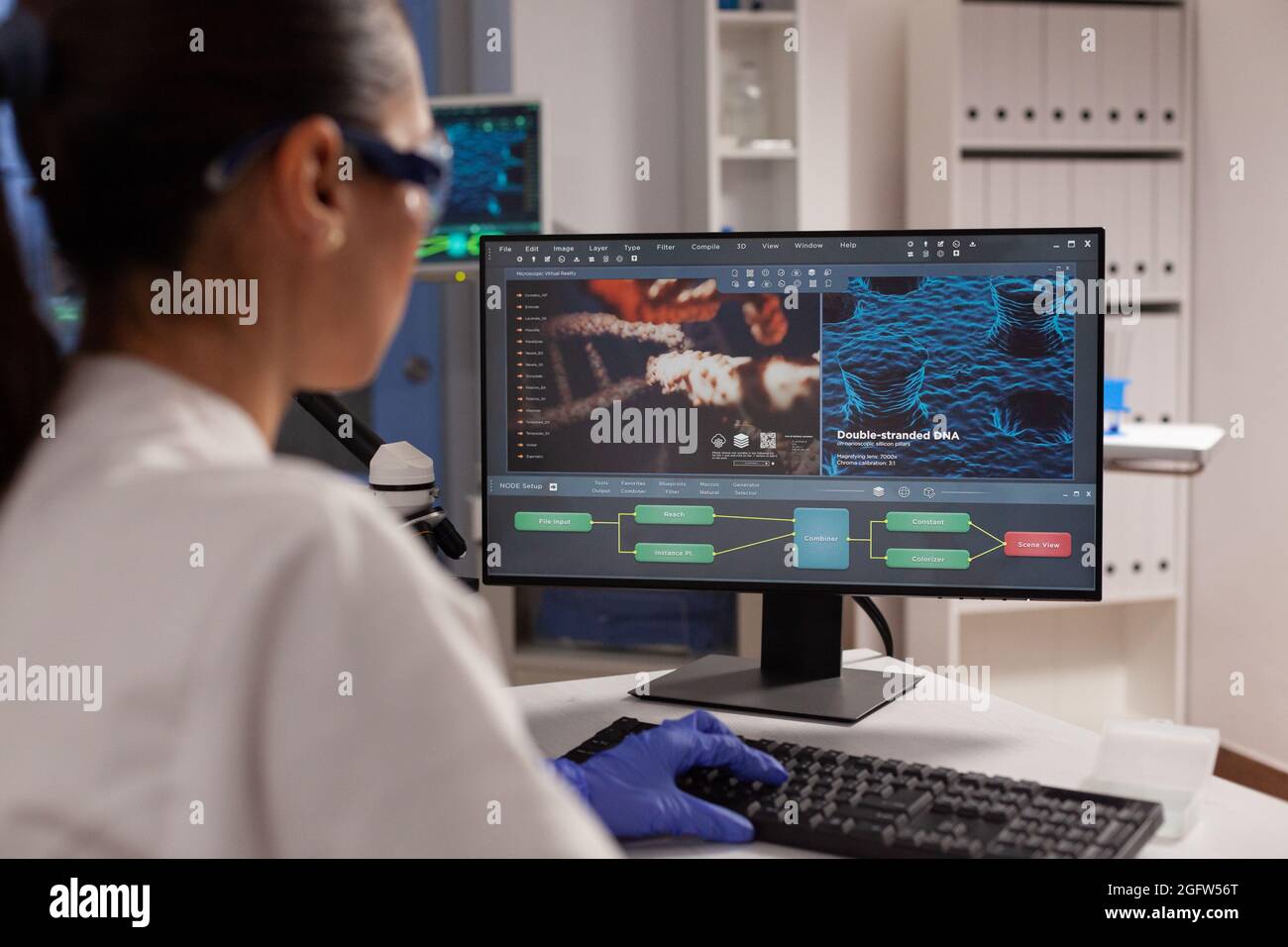 Science specialist using computer for dna research in microbiology ...