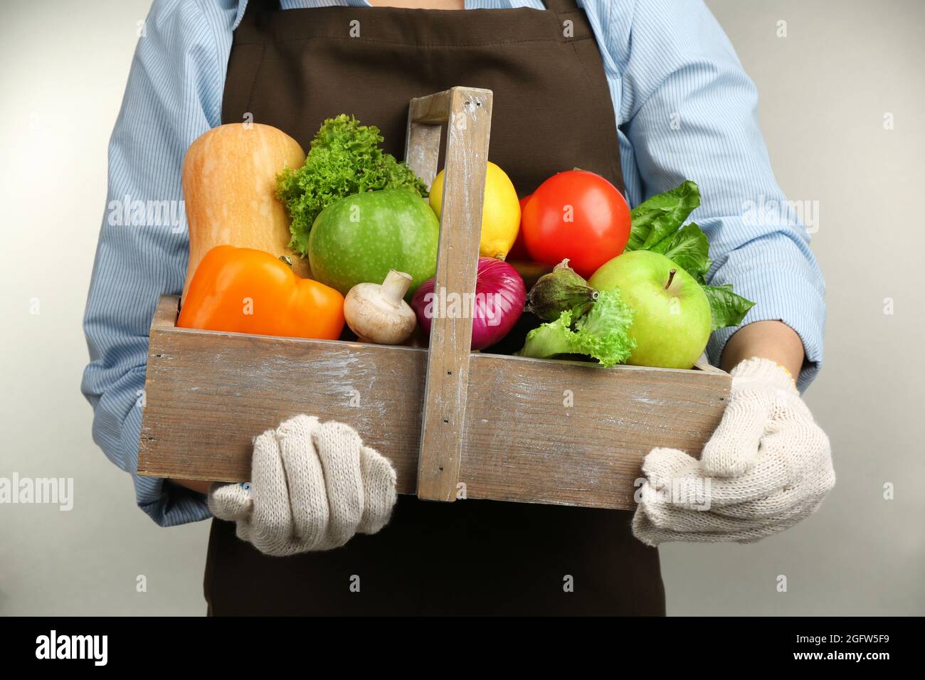 Human hands holding wooden box with different fruits and vegetables ...