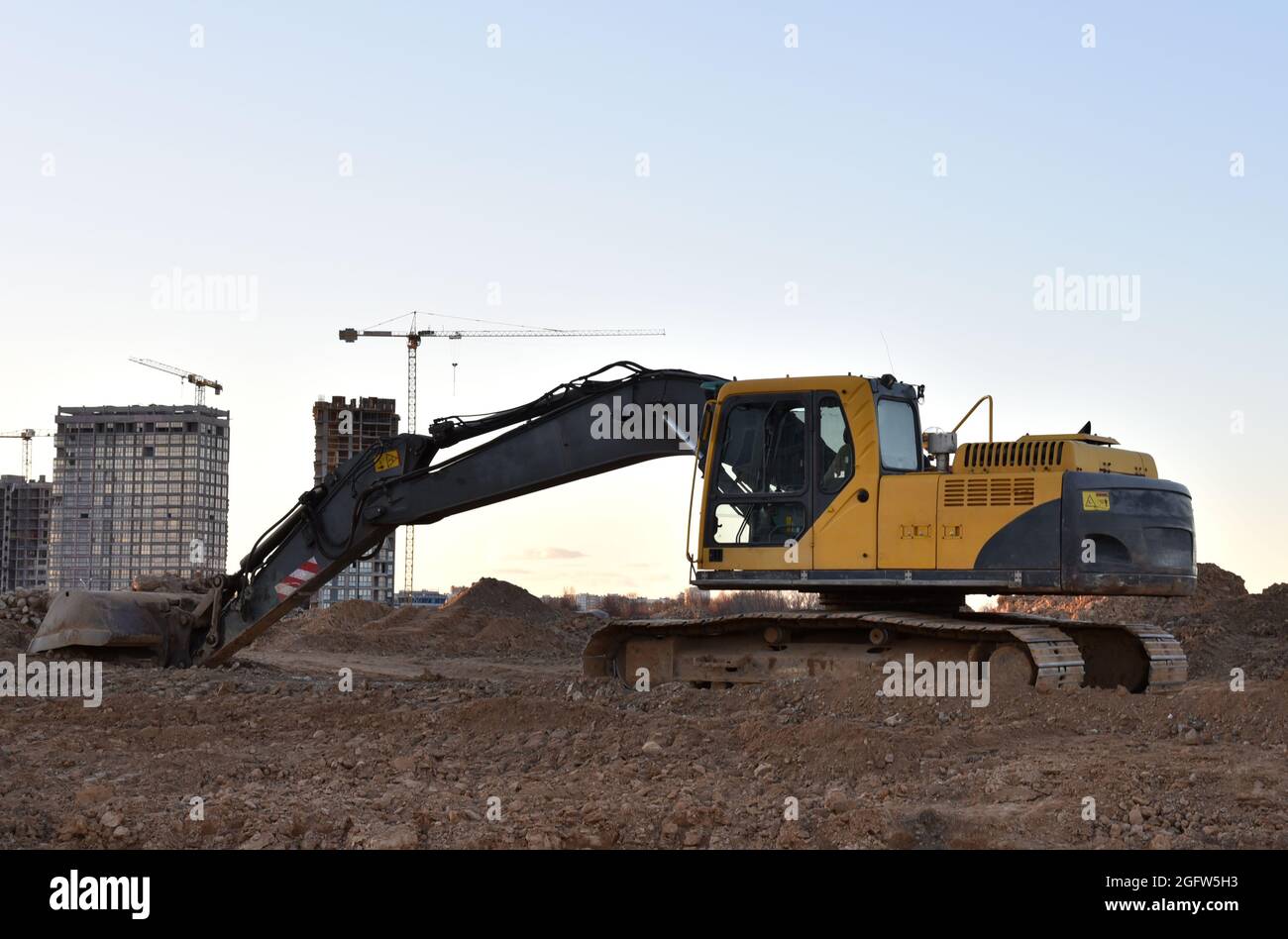 Excavator on earthworks at construction site. Heavy machinery and ...