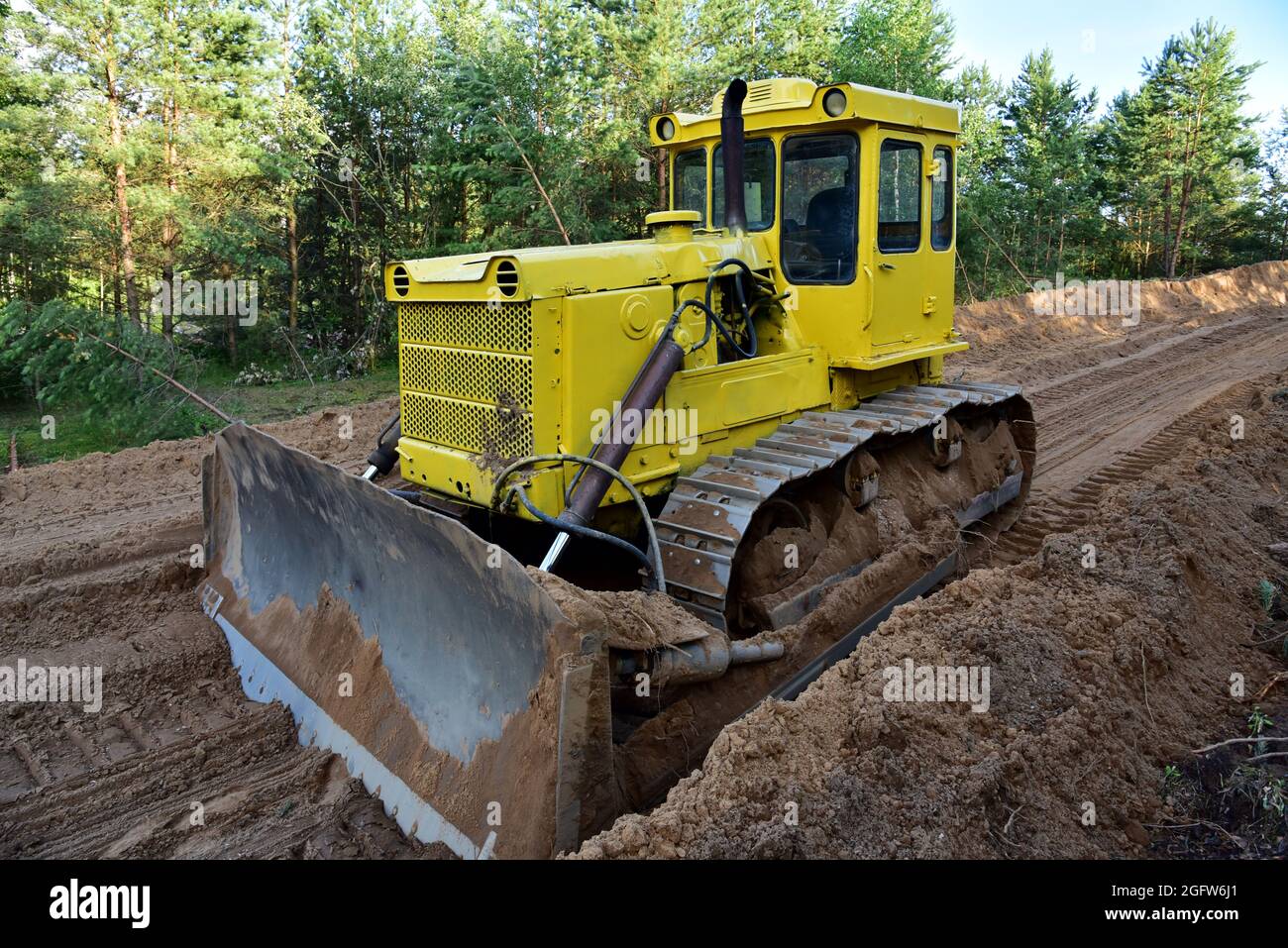 Dozer during clearing forest for construction new road. Bulldozer at ...